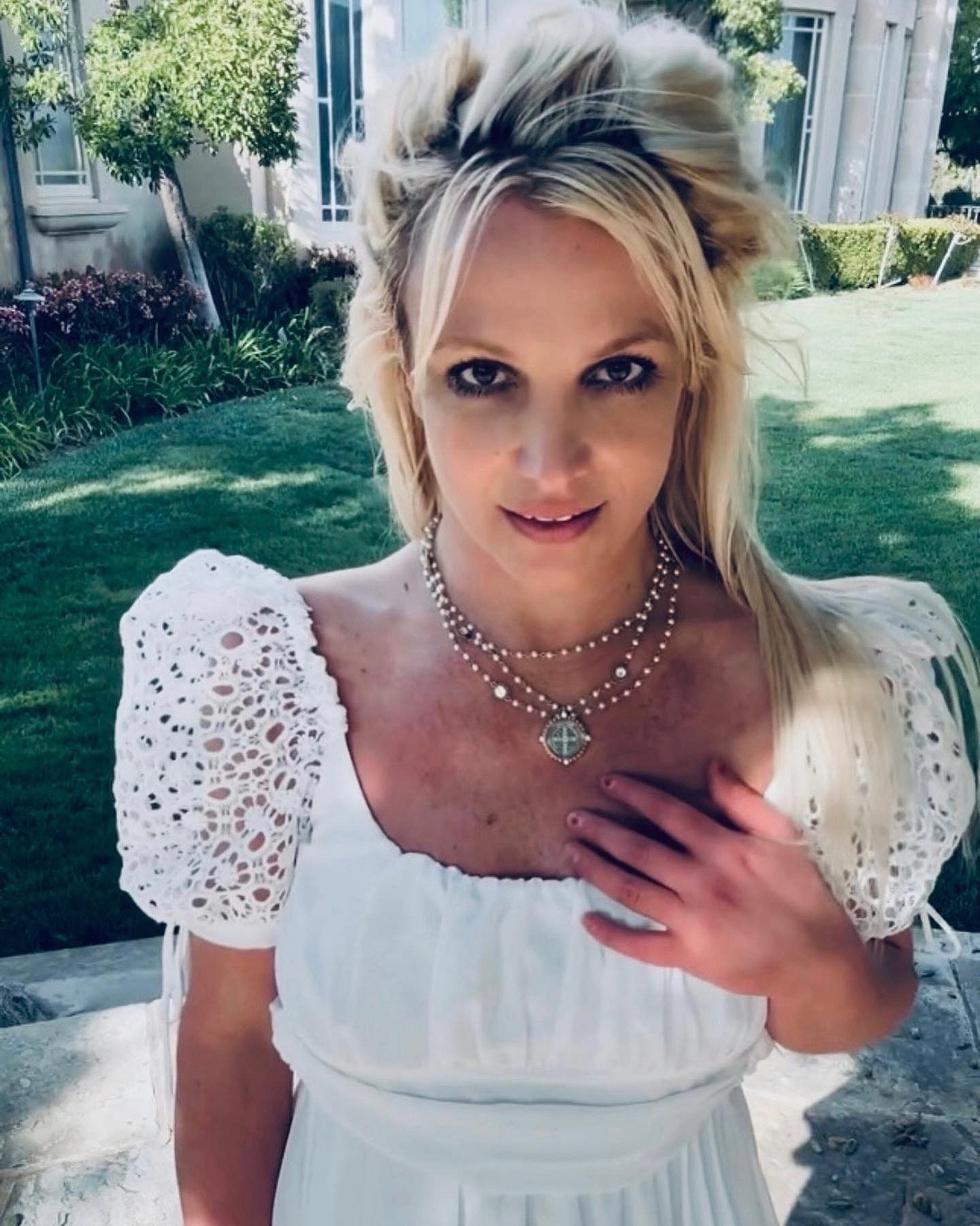 Britney Spears Shows Some Skin Tugging Down Her Dress